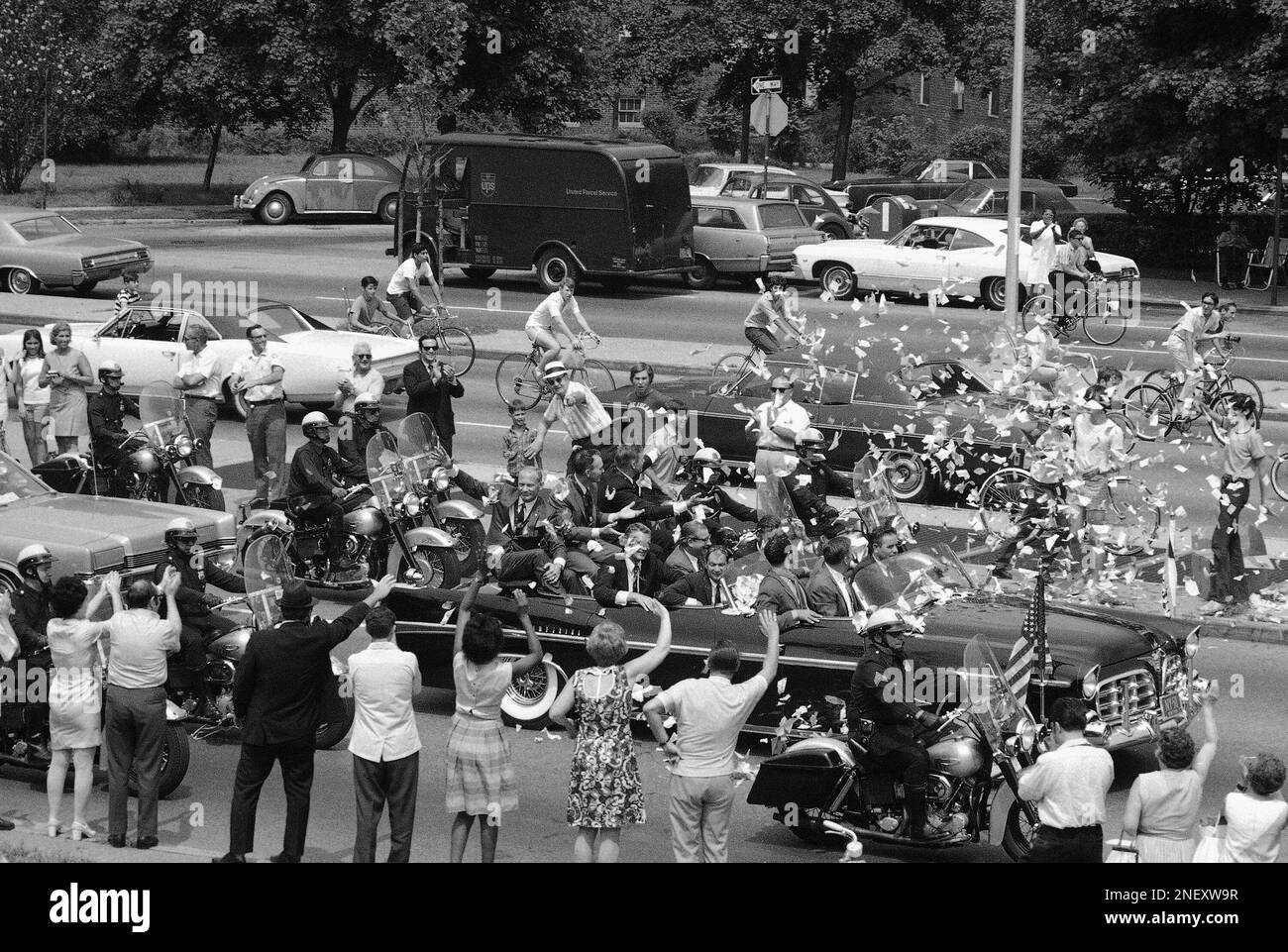 Man at center background points out Apollo 11 astronauts to little boy ...