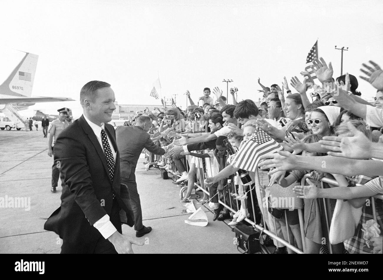 Well-wishers reach for the hands of astronauts Neil Armstrong, left ...