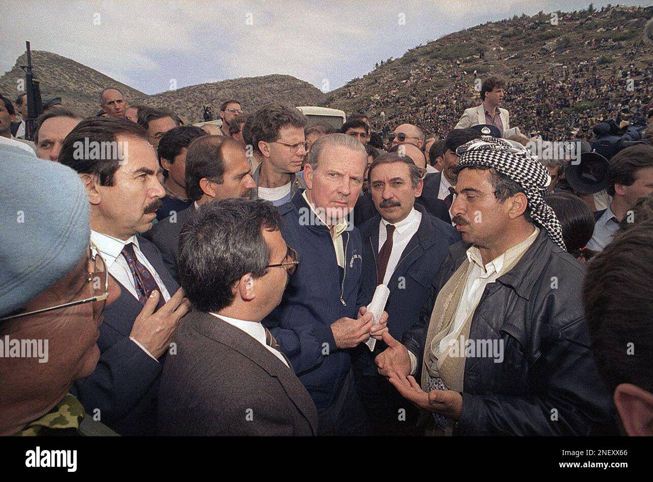 U.S. Secretary of State James Baker speaks with a Kurdish refugee during a brief visit, Monday ...