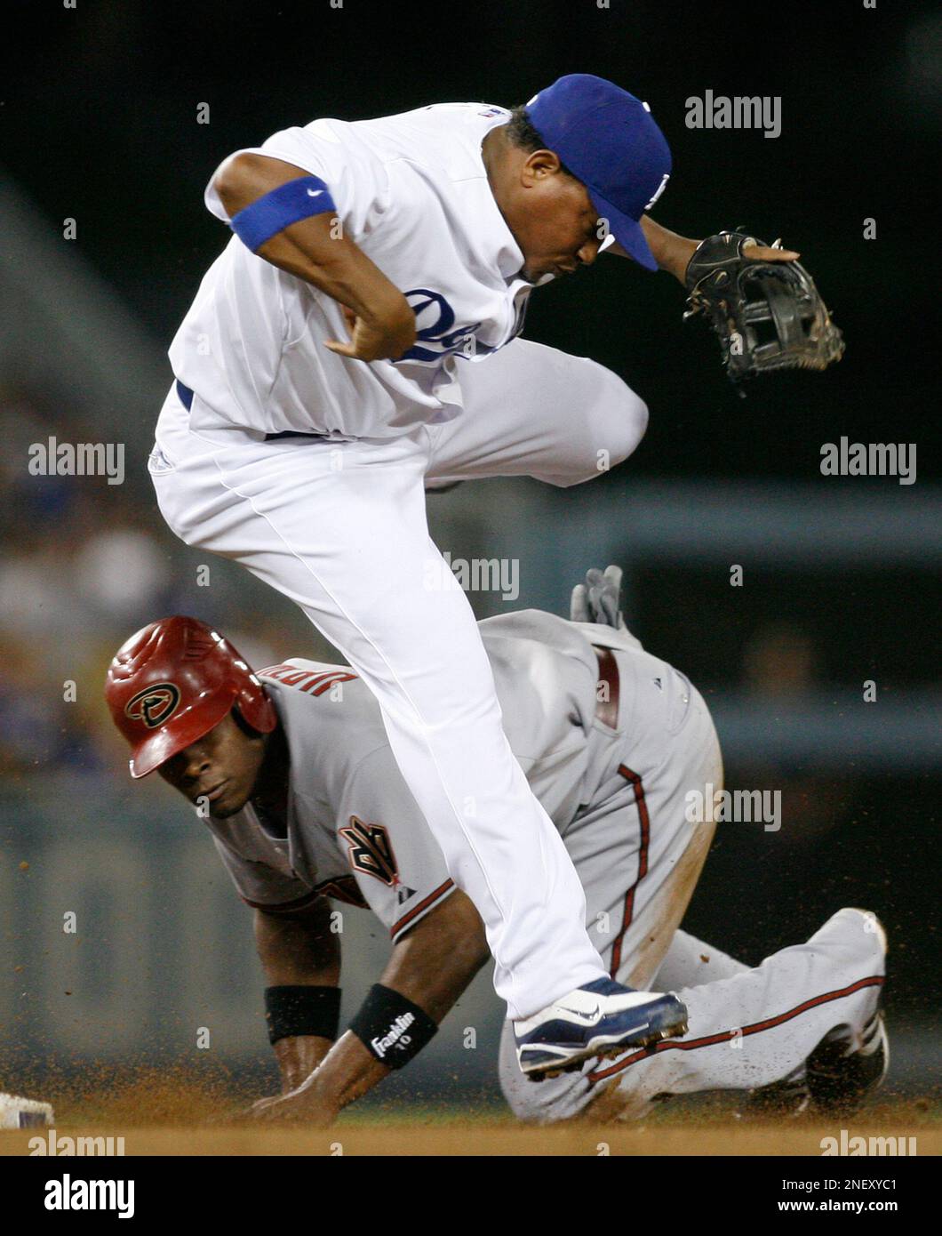 Los Angeles Dodgers second baseman Ronnie Belliard, top, jumps to avoid ...