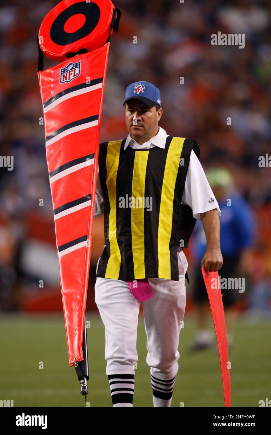 A member of the chain gang moves a marker down field during a preseason ...