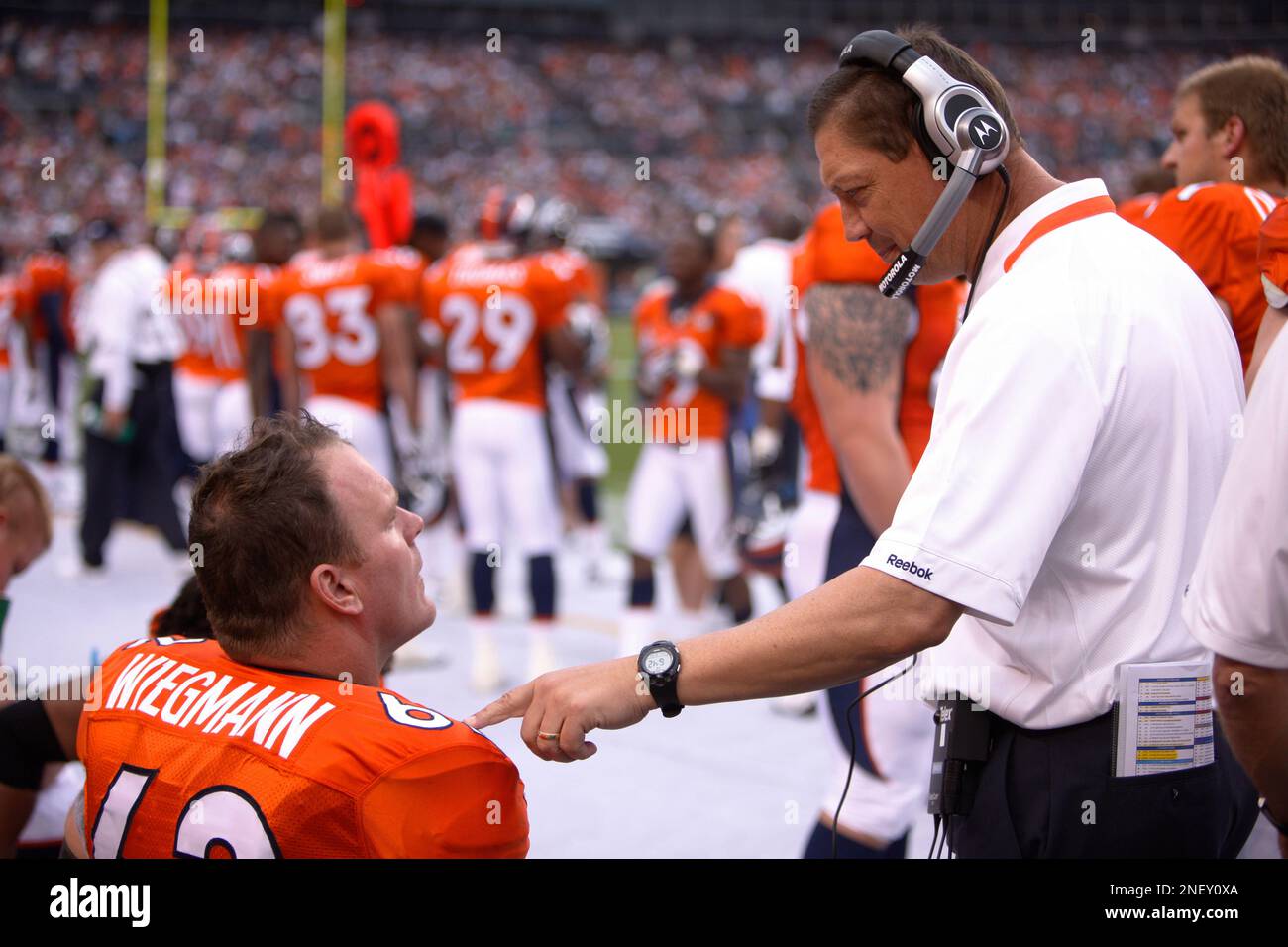 Denver Broncos offensive line coach Rick Dennison talks to center Casey ...