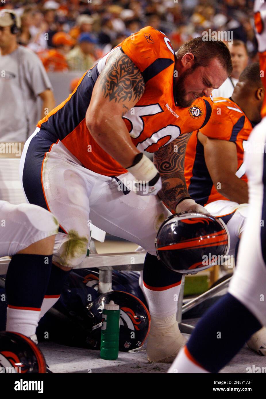 Denver Broncos guard Matt McChesney punches his helmet in frustration ...