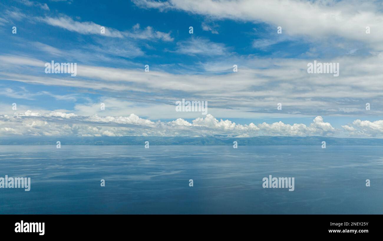 Top view of the island of Cebu from the sea. Blue ocean and sky with ...