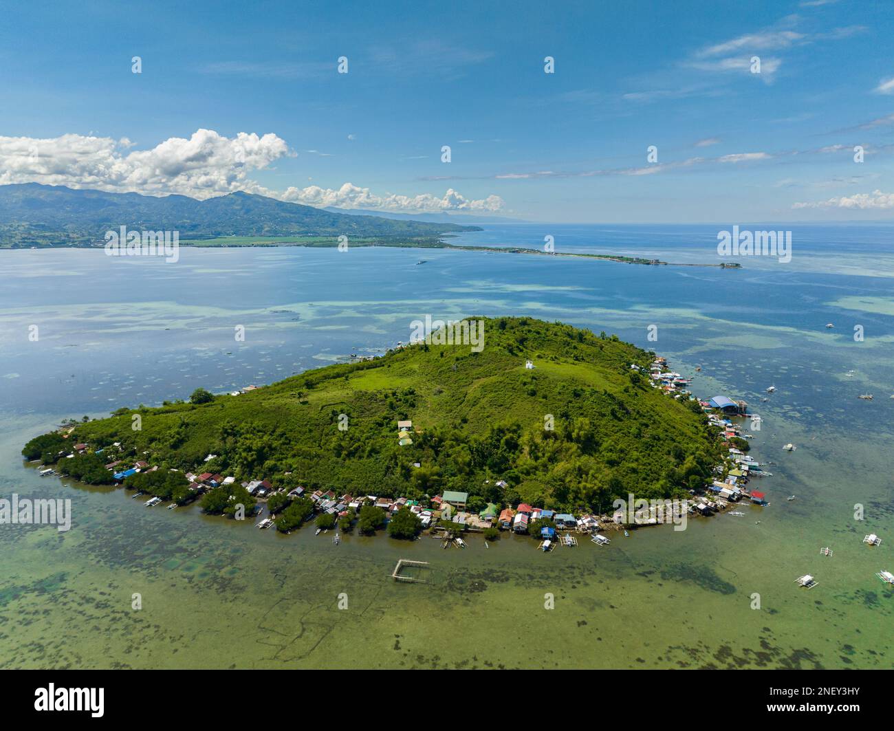 Aerial drone of tropical island with a fishing village. Diutay Island ...
