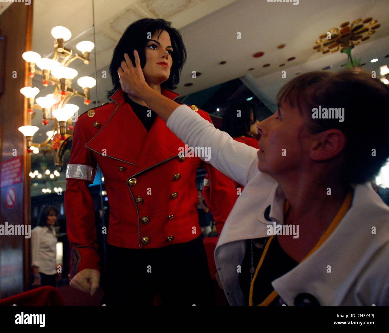 A life-size wax model of US singer Michael Jackson is dressed by a ...