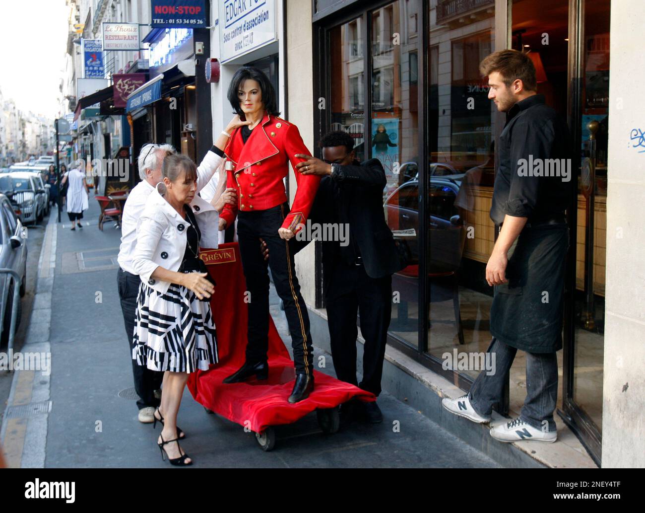 A life-size wax model of US singer Michael Jackson is carried by Grevin ...