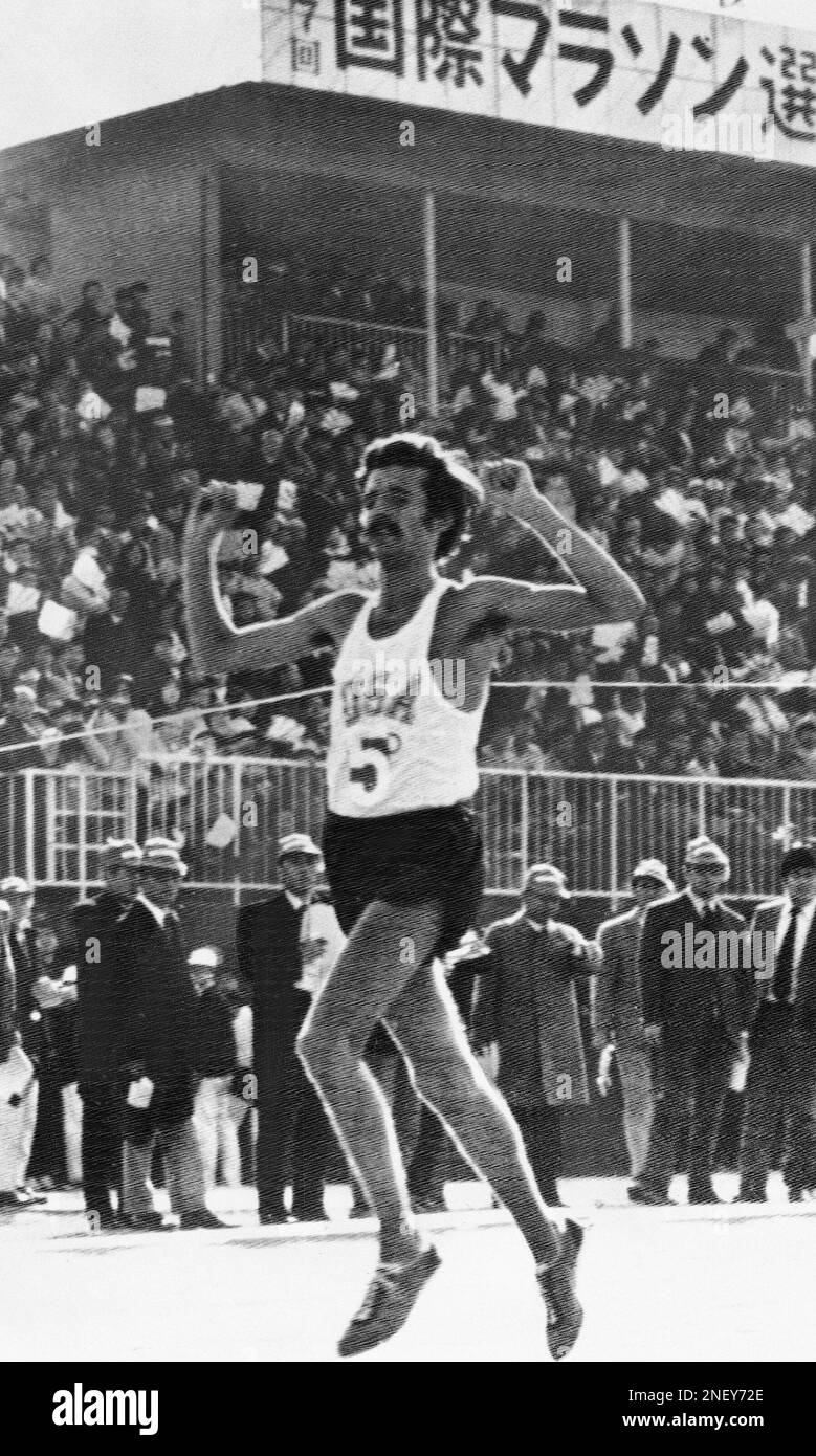 U.S. Olympic Gold Medal winner Frank Shorter breaks the tape to win the ...
