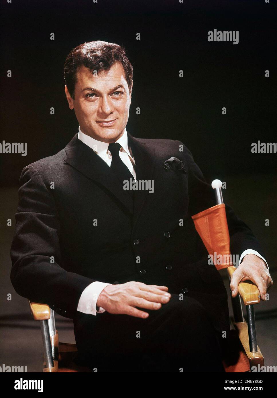Actor Tony Curtis is shown seated in a studio chair, in an unknown ...