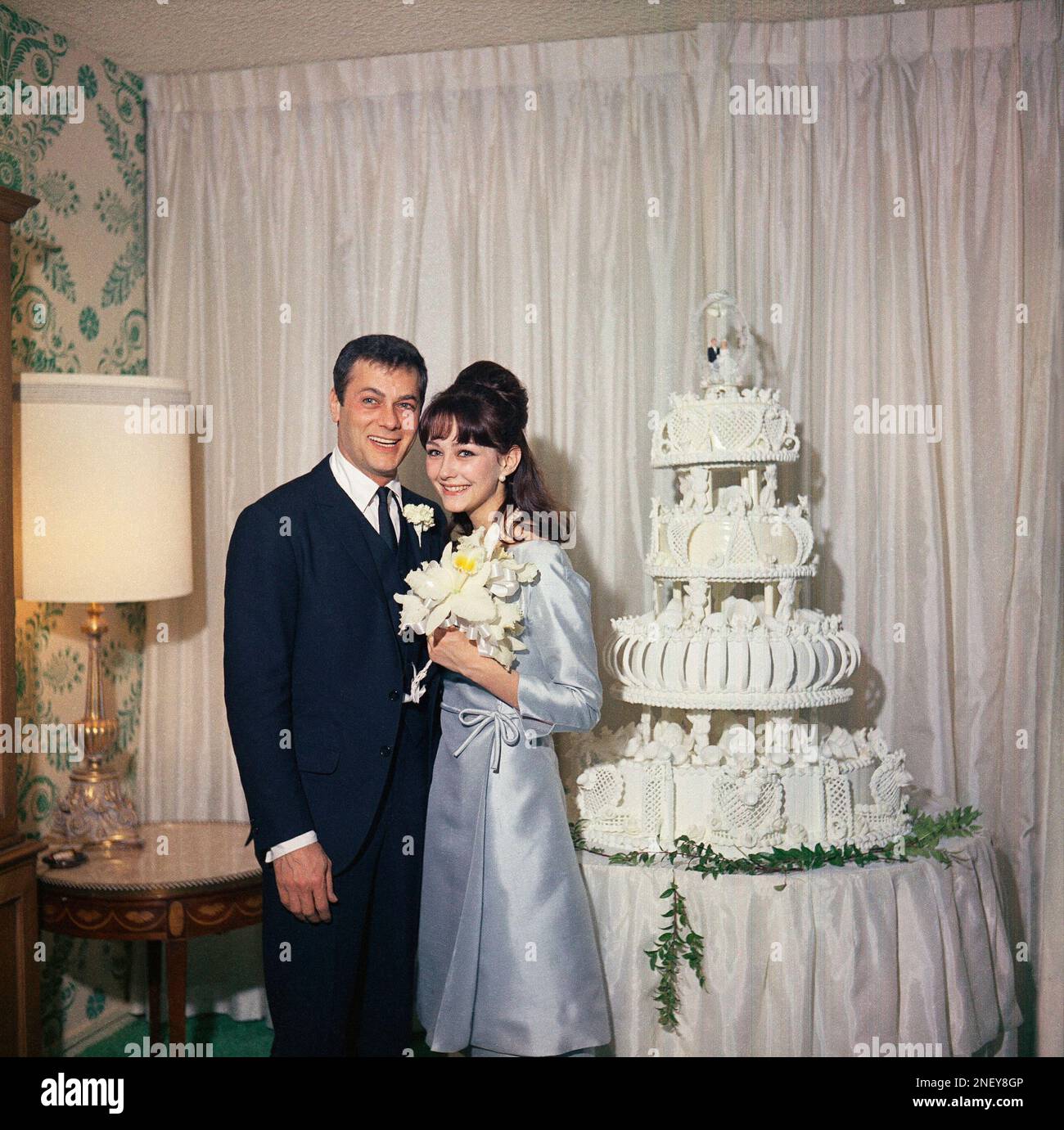 Actor Tony Curtis, and his new wife Christine Kaufmann stand next to ...