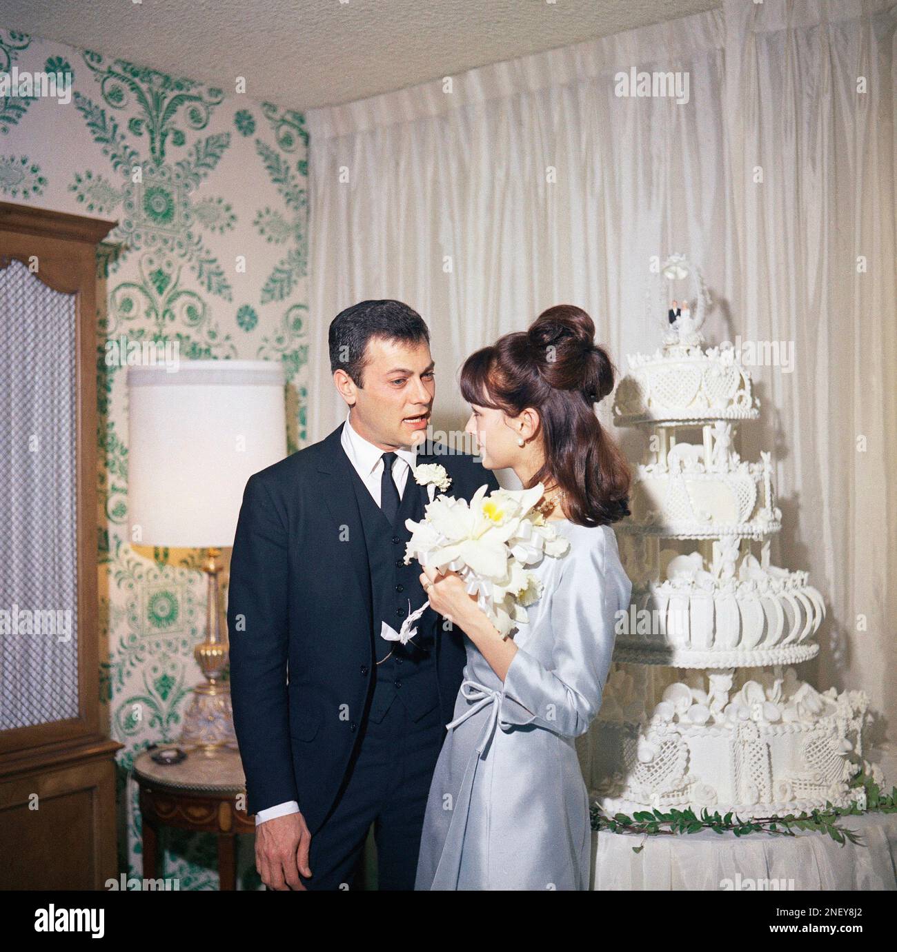 Actor Tony Curtis, and his new wife Christine Kaufmann stand next to ...