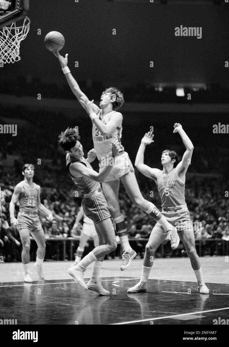 North Carolina’s Lee Dedmon topples his defender, Tommy Wilson, dark ...
