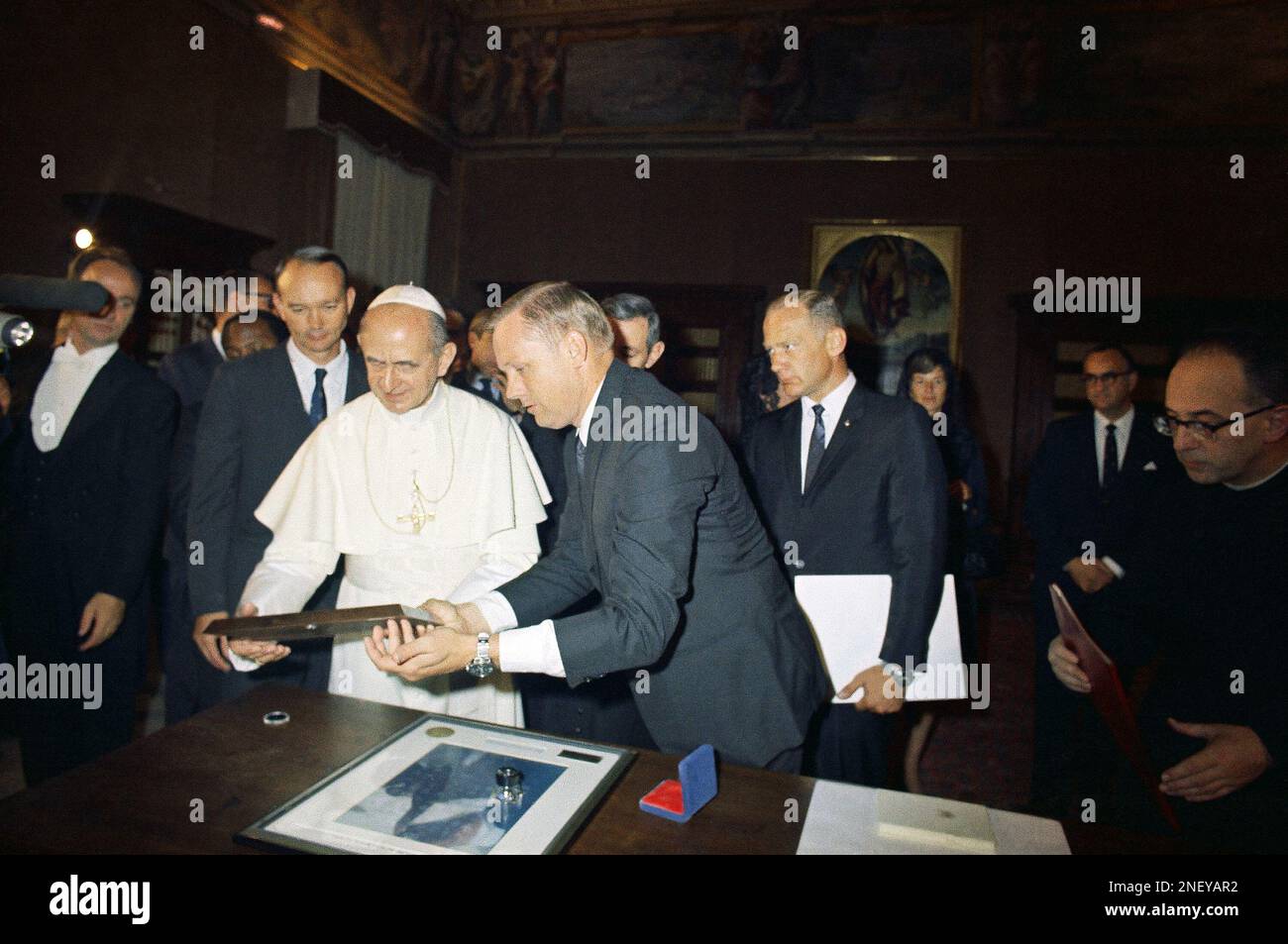 Neil Armstrong, commander of the Apollo 11 moon flight, presents Pope Paul VI with a photo of ...