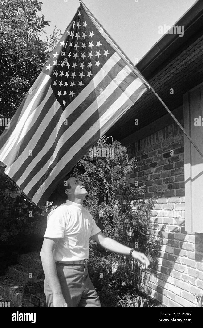 Dean Armstrong, brother of Astronaut Neil Armstrong, puts the flag in ...