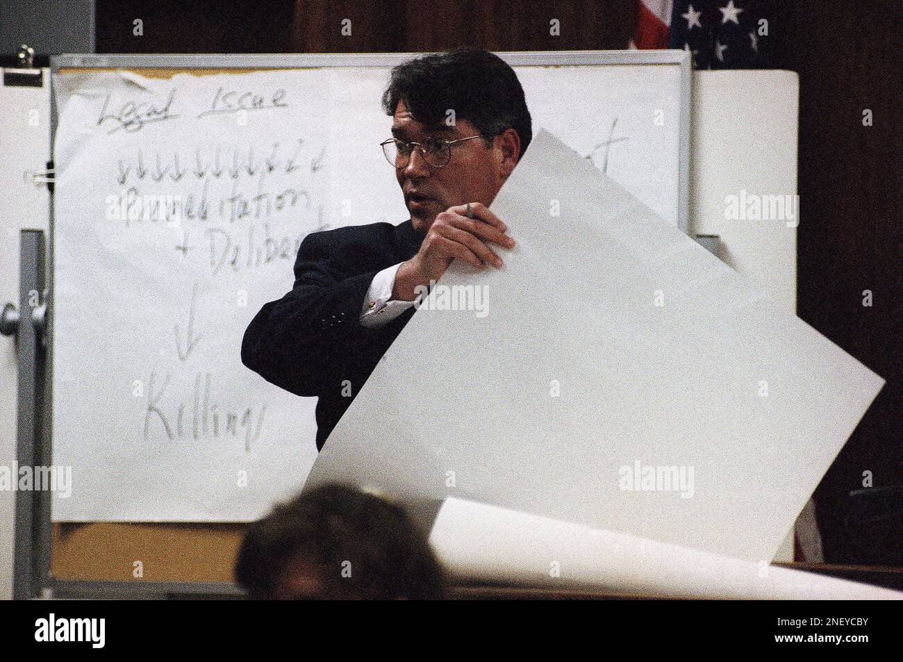 Los Angeles County Deputy District Attorney David Conn moves a display ...