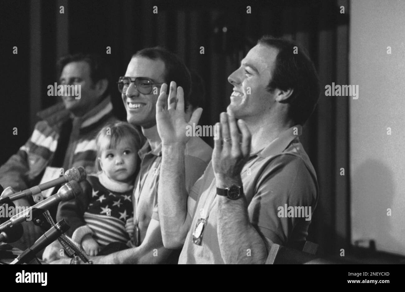 American skier Phil Mahre, right, throws his hands up in reaction to ...
