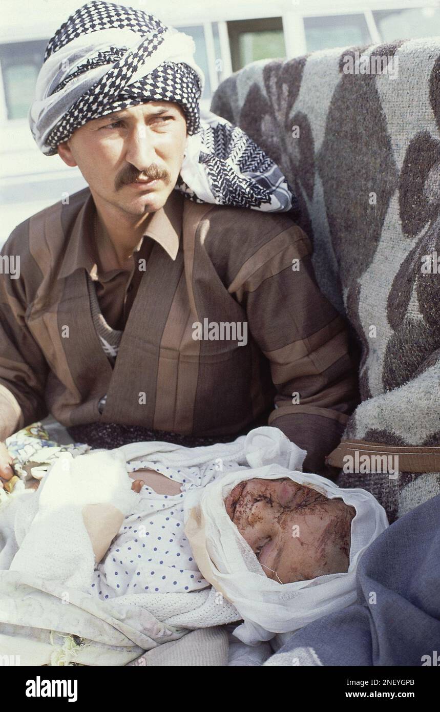 A Kurdish man holds the body of his daughter last weekend, killed by ...