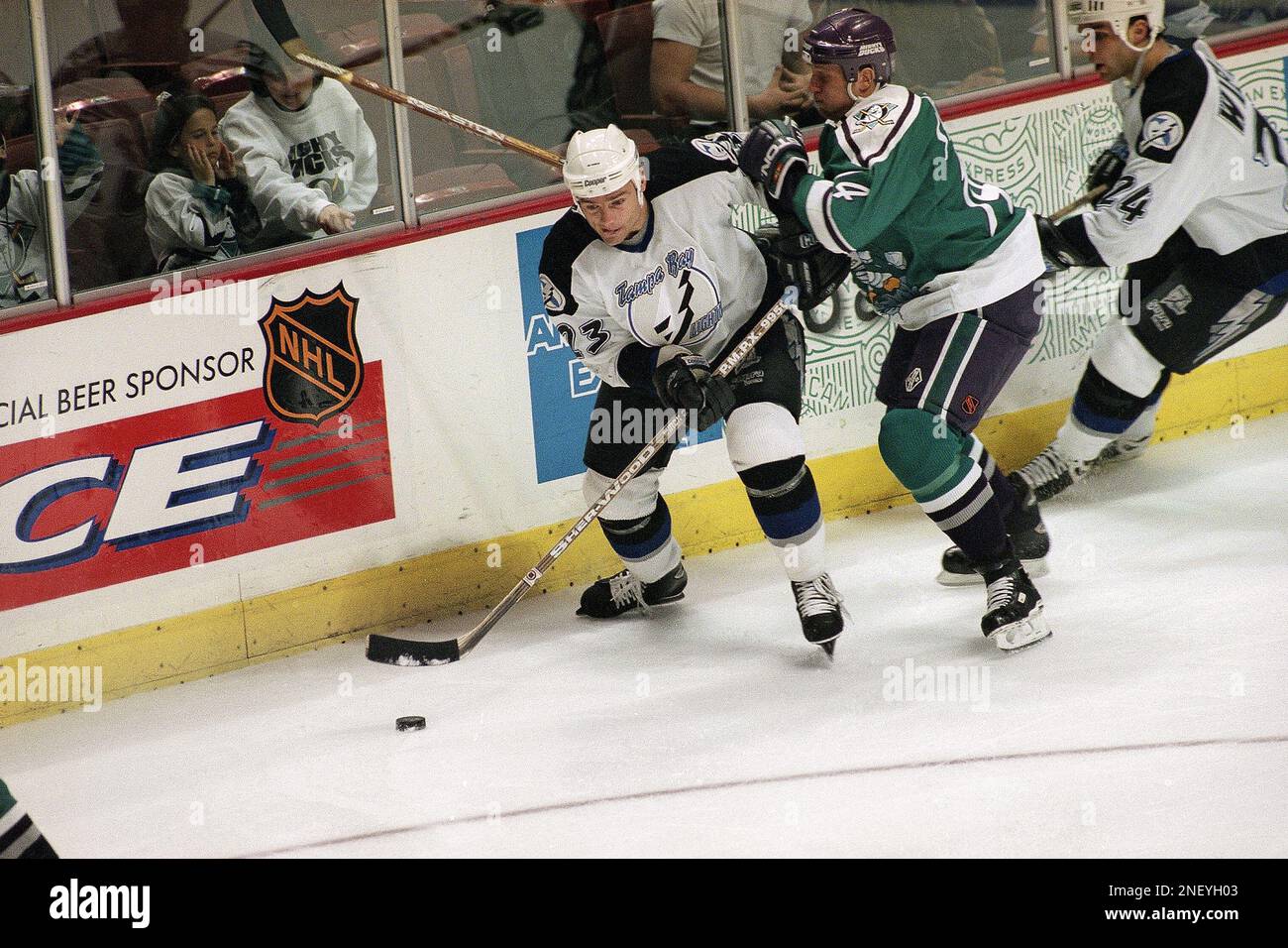 Tampa Bay Lightning Brian Bellows, left, gets checked by Mighty Duck ...