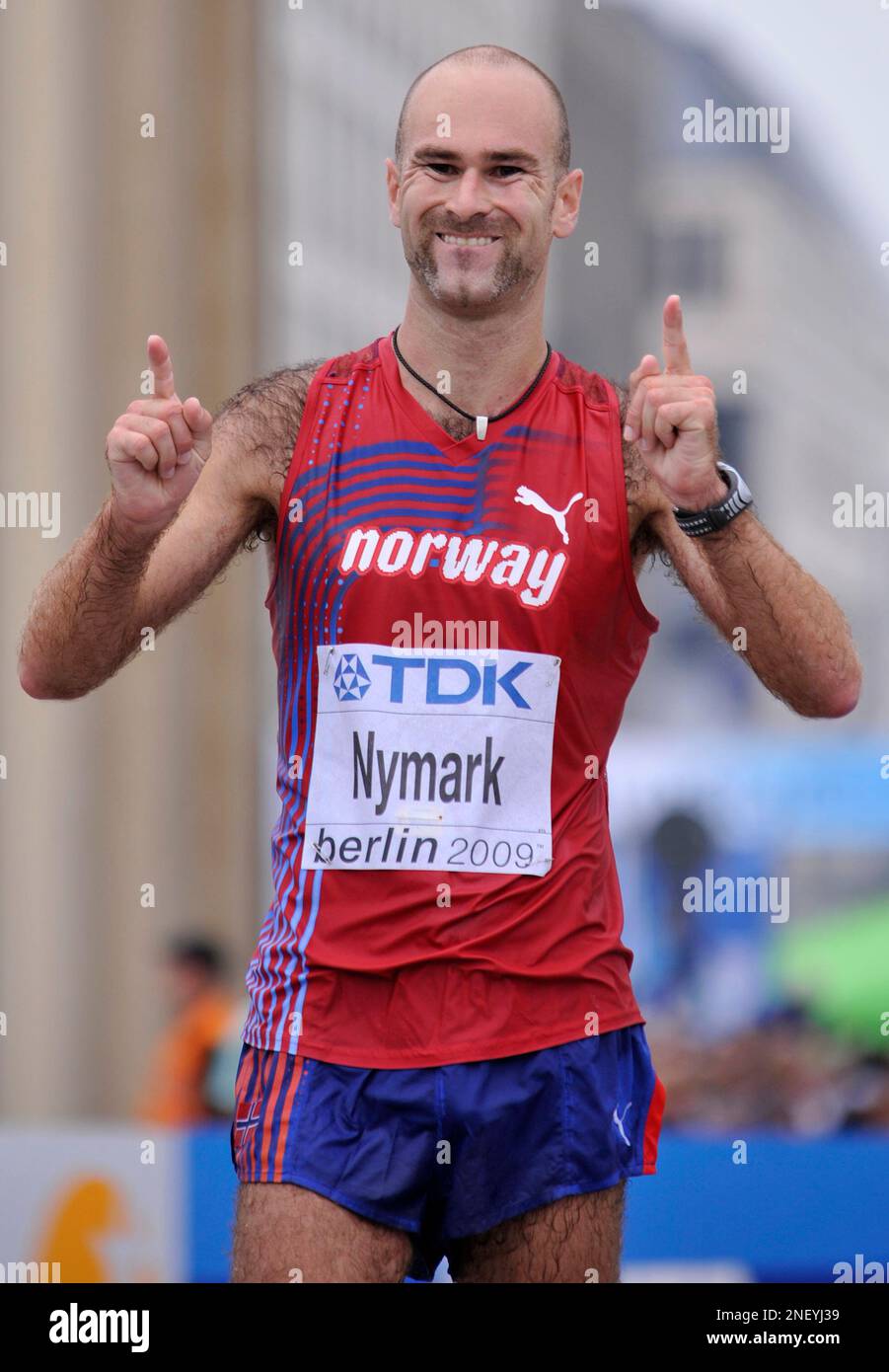 Norway's Trond Nymark reacts as he crosses the finish line to win ...