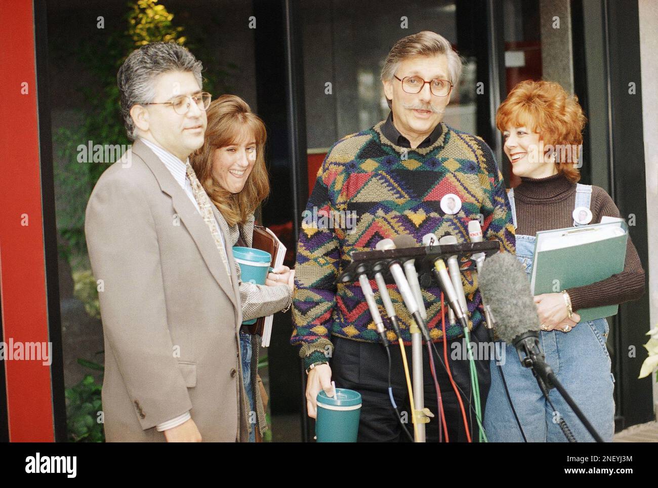 As his wife Patti, far right, and daughter Kim smile in the background ...