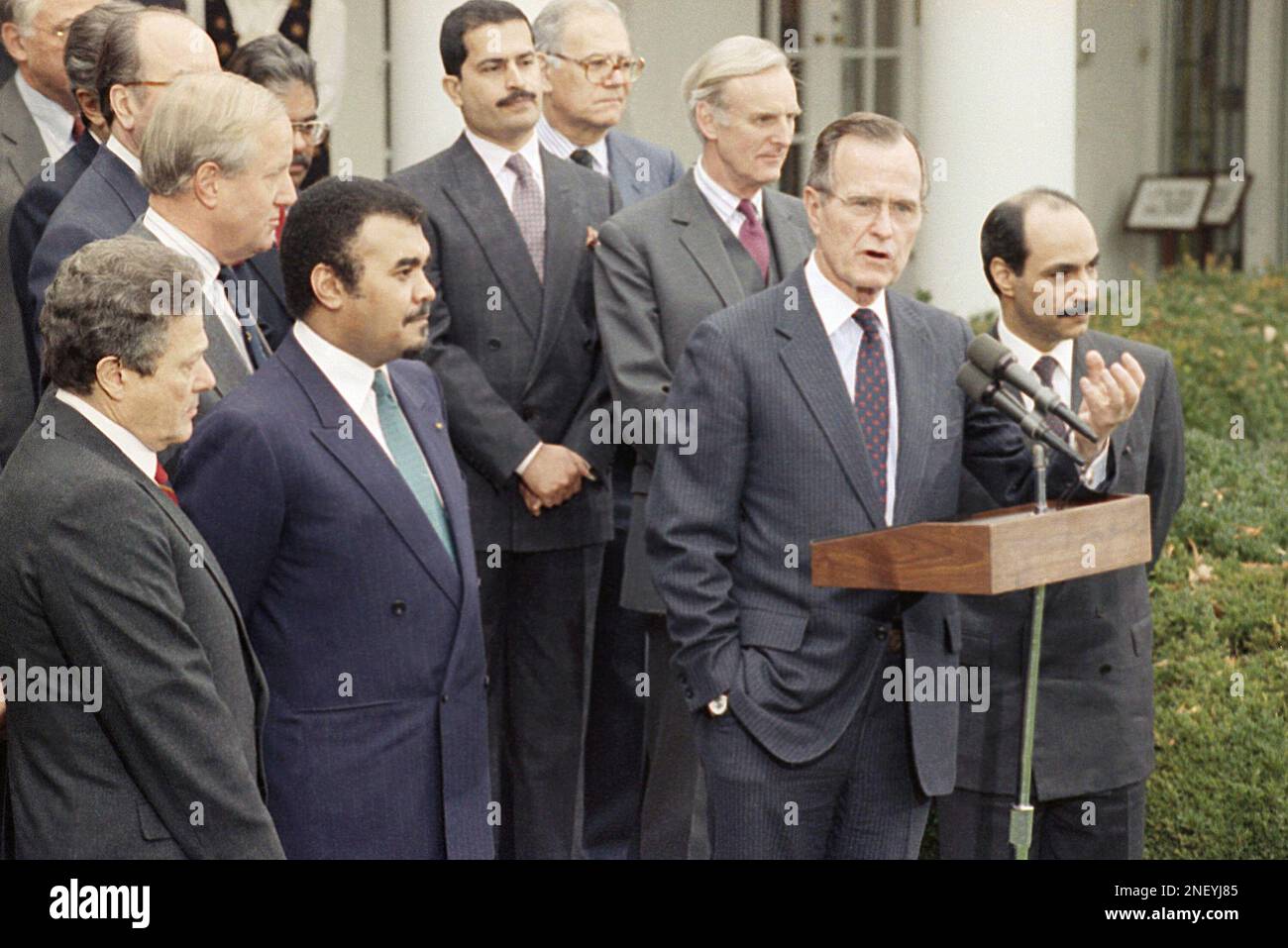 President George H. Bush gestures while speaking to reporters in the ...