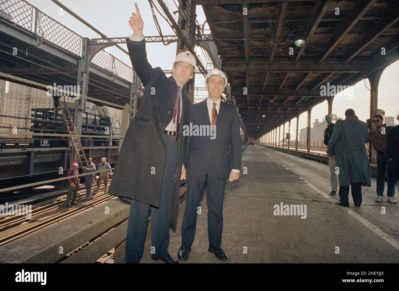 Real estate developer Donald Trump, left, points to structures of the ...