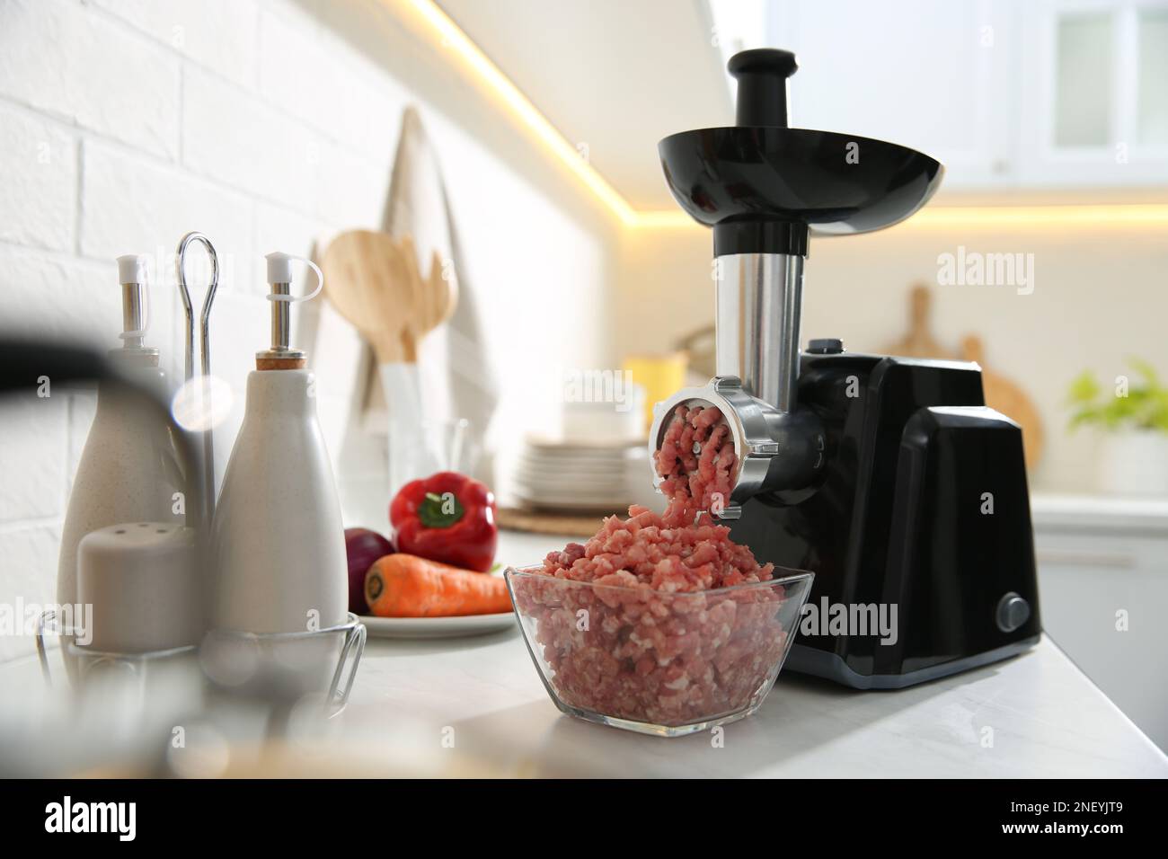 Modern meat grinder and products on white table in kitchen Stock Photo ...