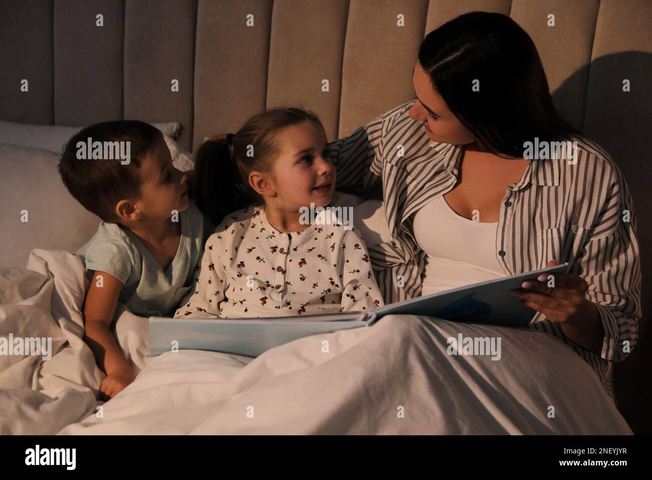 Woman reading bedtime story children hi-res stock photography and ...
