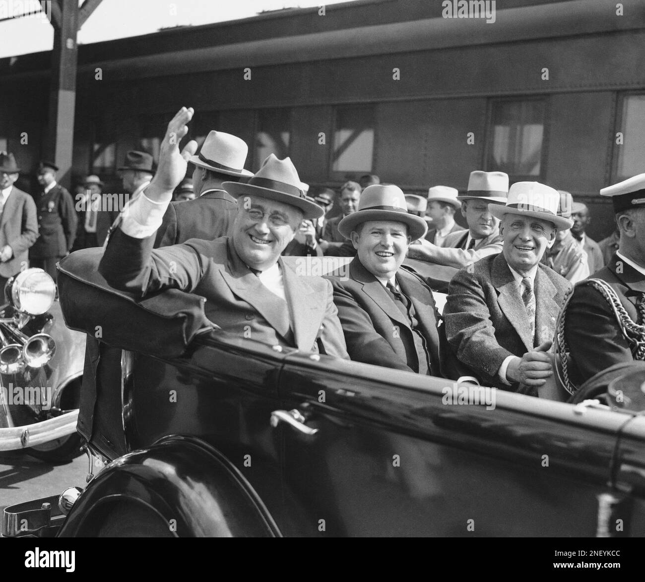 The famous Roosevelt smile flashes as the President waves to cheering ...