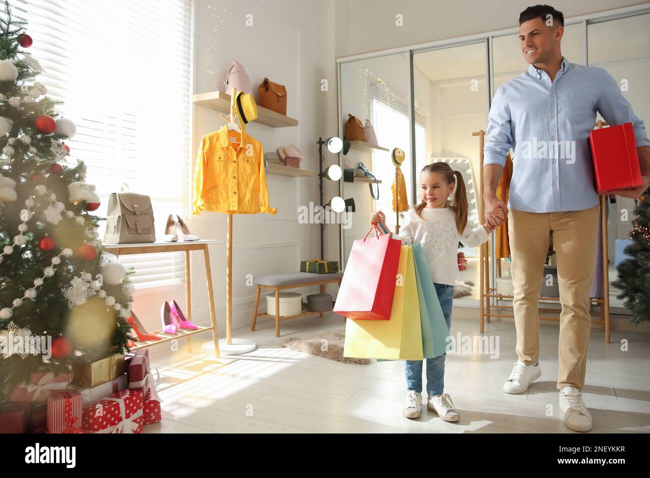 Father and daughter with bags in store. Family Christmas shopping Stock ...