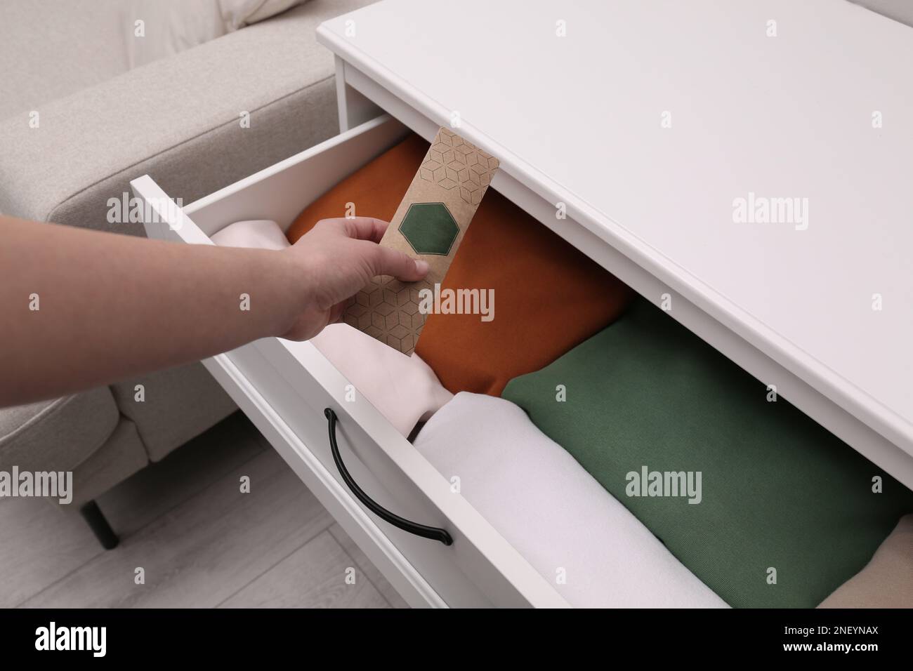 Woman putting scented sachet into drawer with clothes, closeup Stock ...