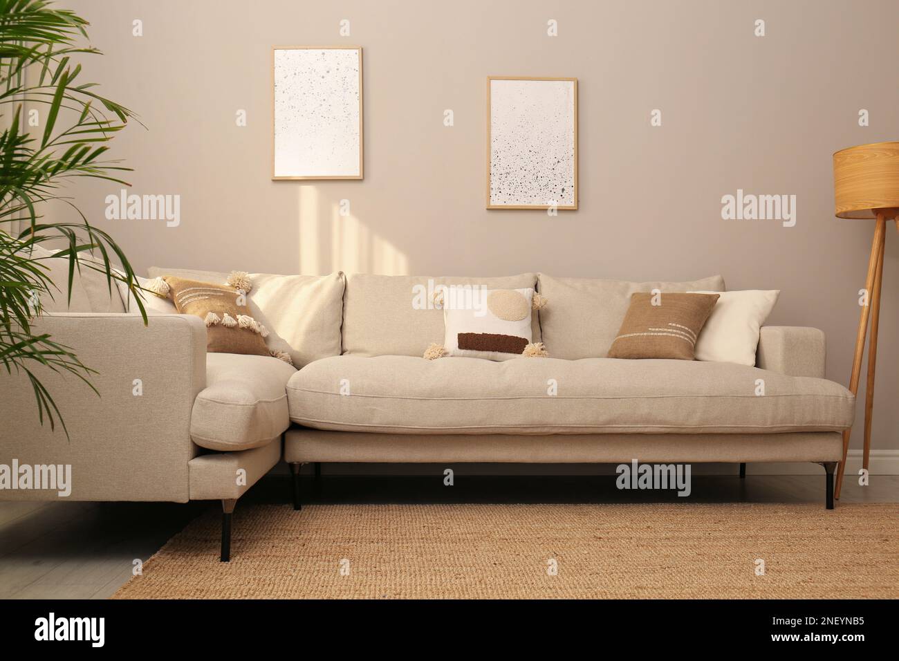 Stylish living room interior with modern comfortable sofa and pictures ...