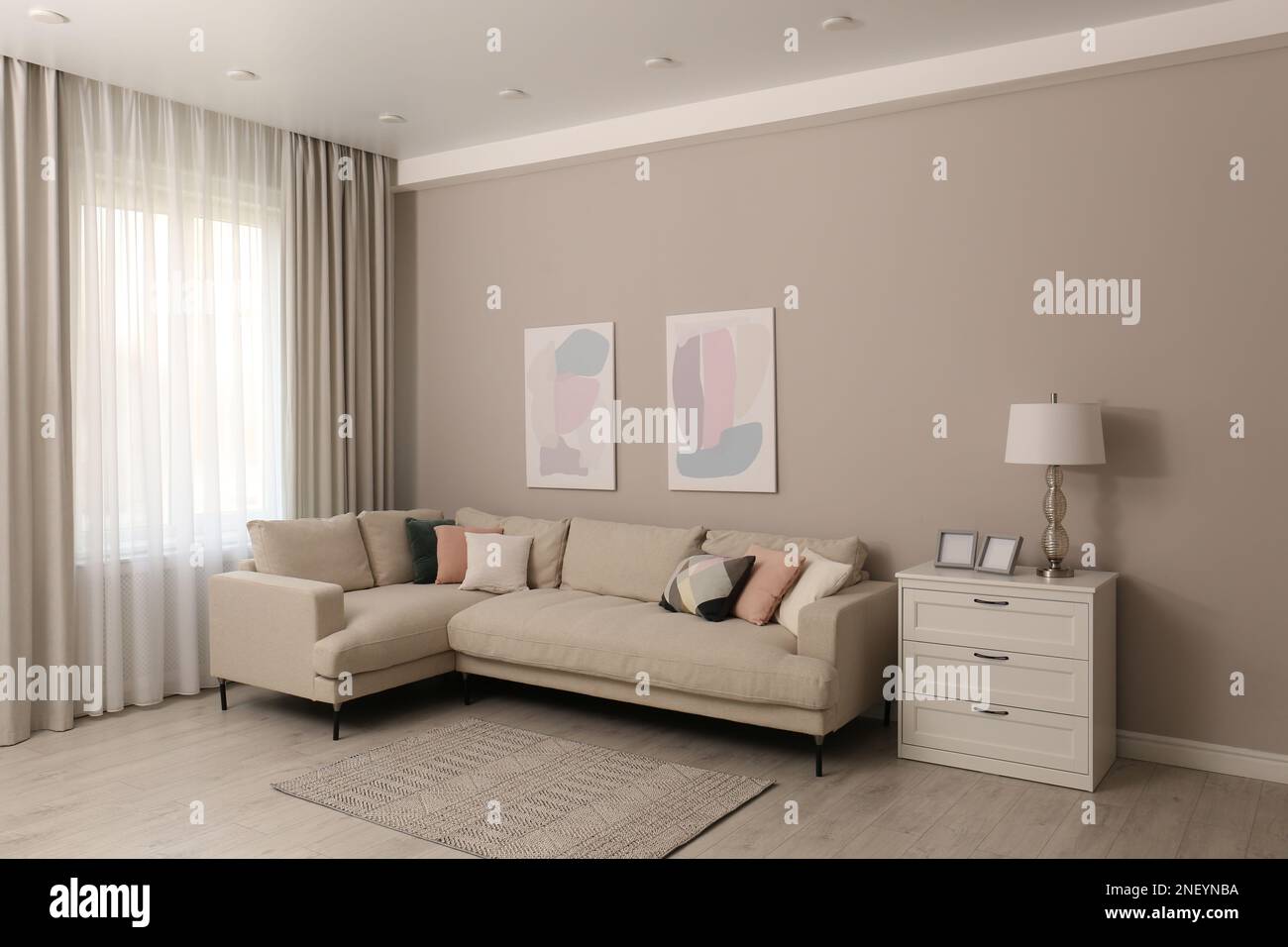 Stylish living room interior with modern comfortable sofa and pictures ...