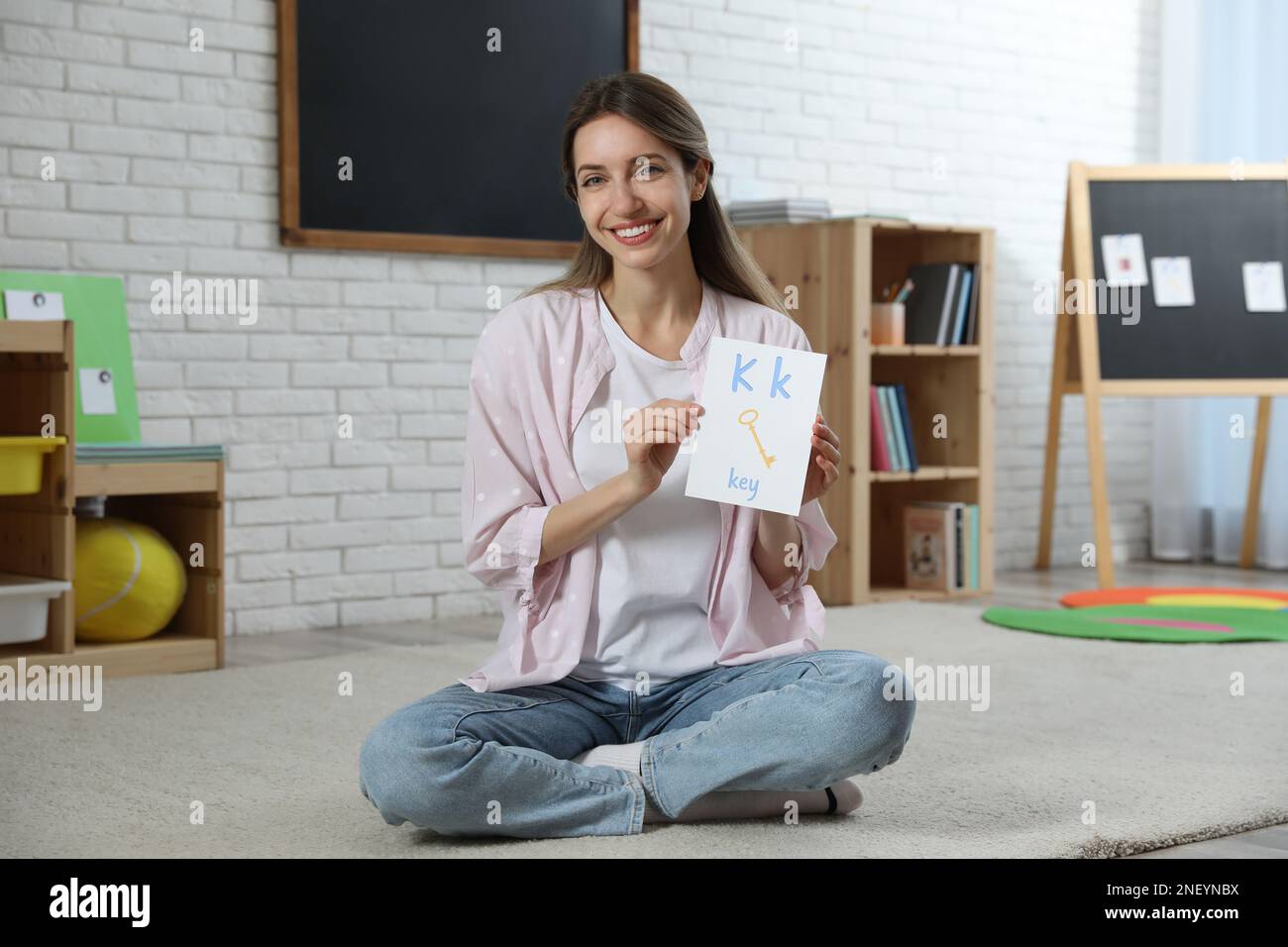 Happy female English teacher giving lesson in elementary school Stock ...