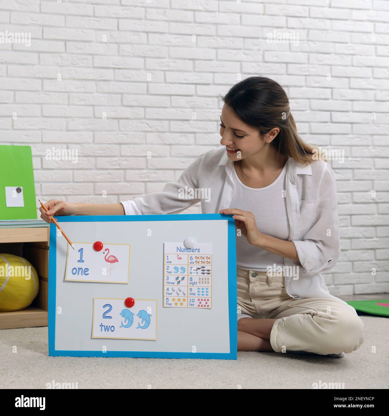 Happy female English teacher giving lesson in elementary school Stock ...