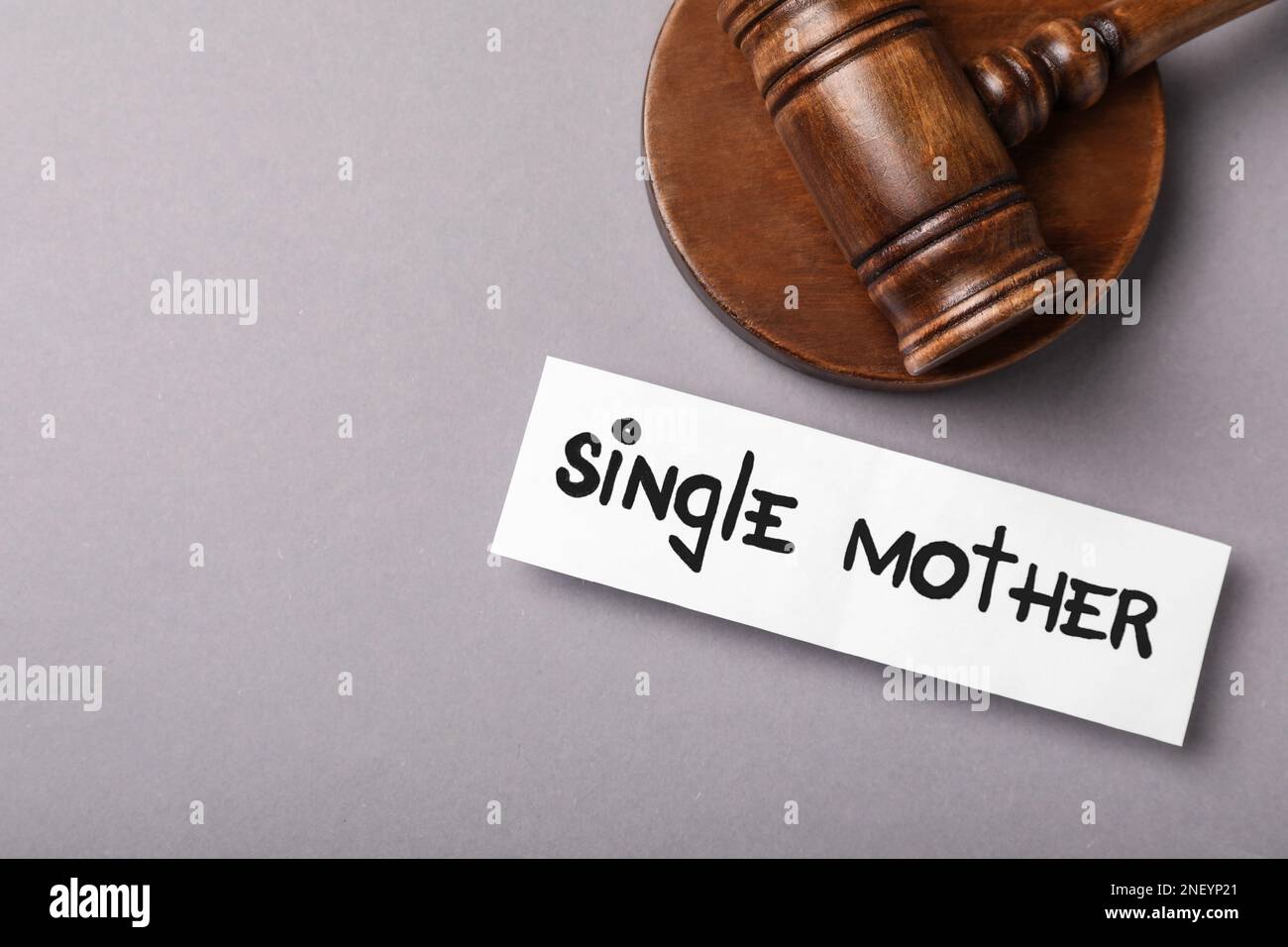 Being single mother after divorce concept. Card and judge gavel on grey ...