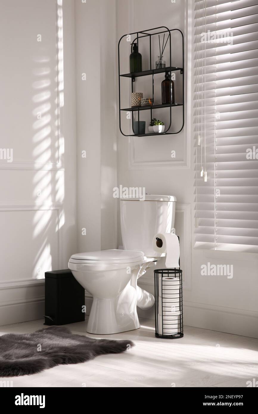 Modern toilet bowl in comfortable restroom. Interior design Stock Photo ...
