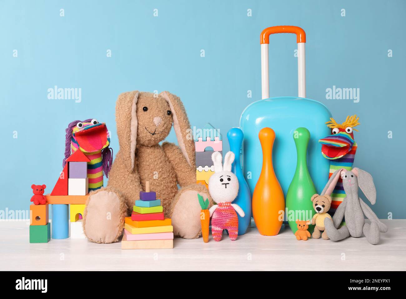 Collection of different toys on white wooden table Stock Photo - Alamy