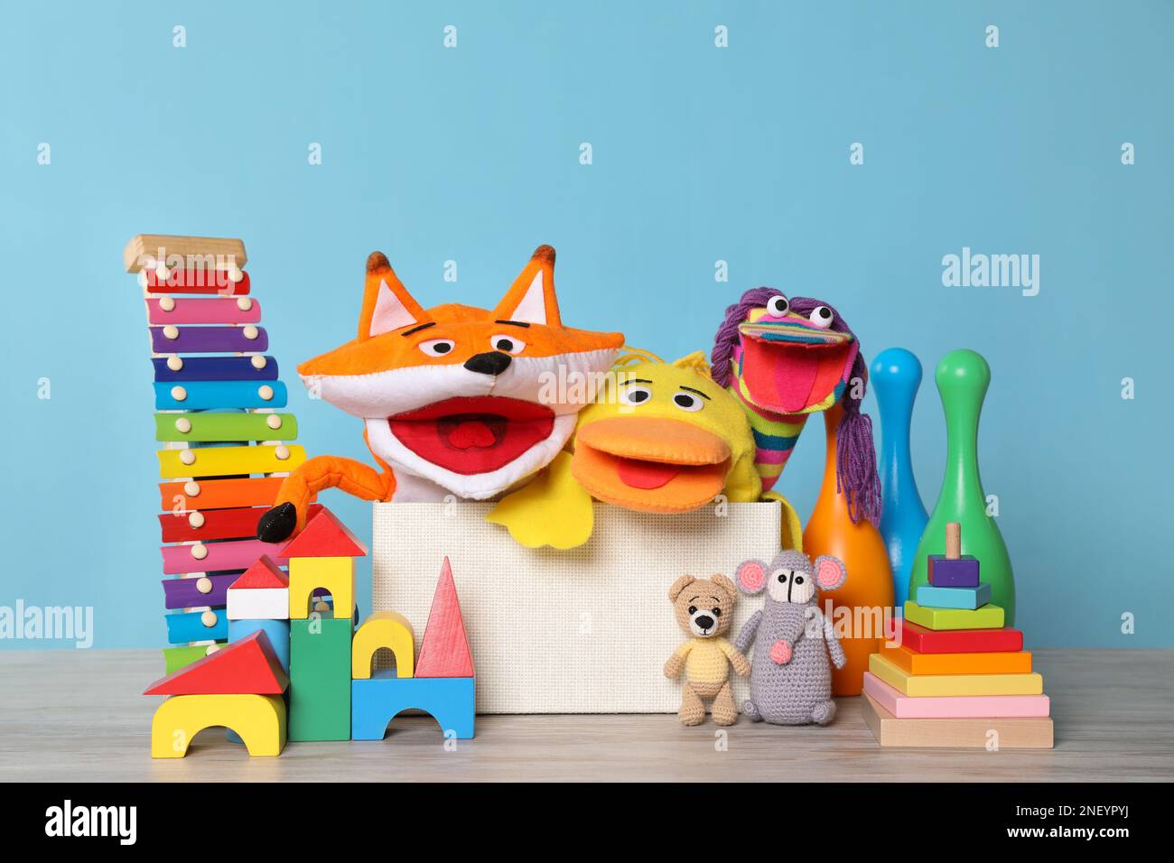 Collection of different toys on white wooden table Stock Photo - Alamy