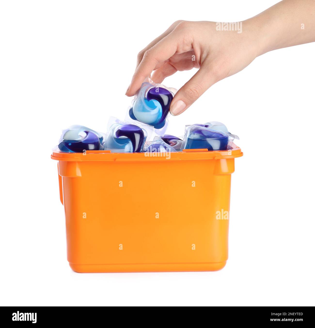 Woman taking laundry capsule out of box against white background ...