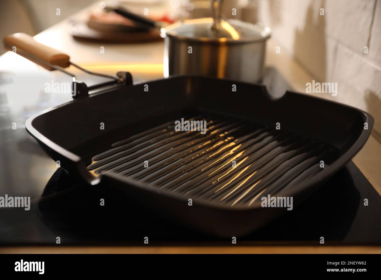 Frying pan with cooking oil on stove Stock Photo - Alamy