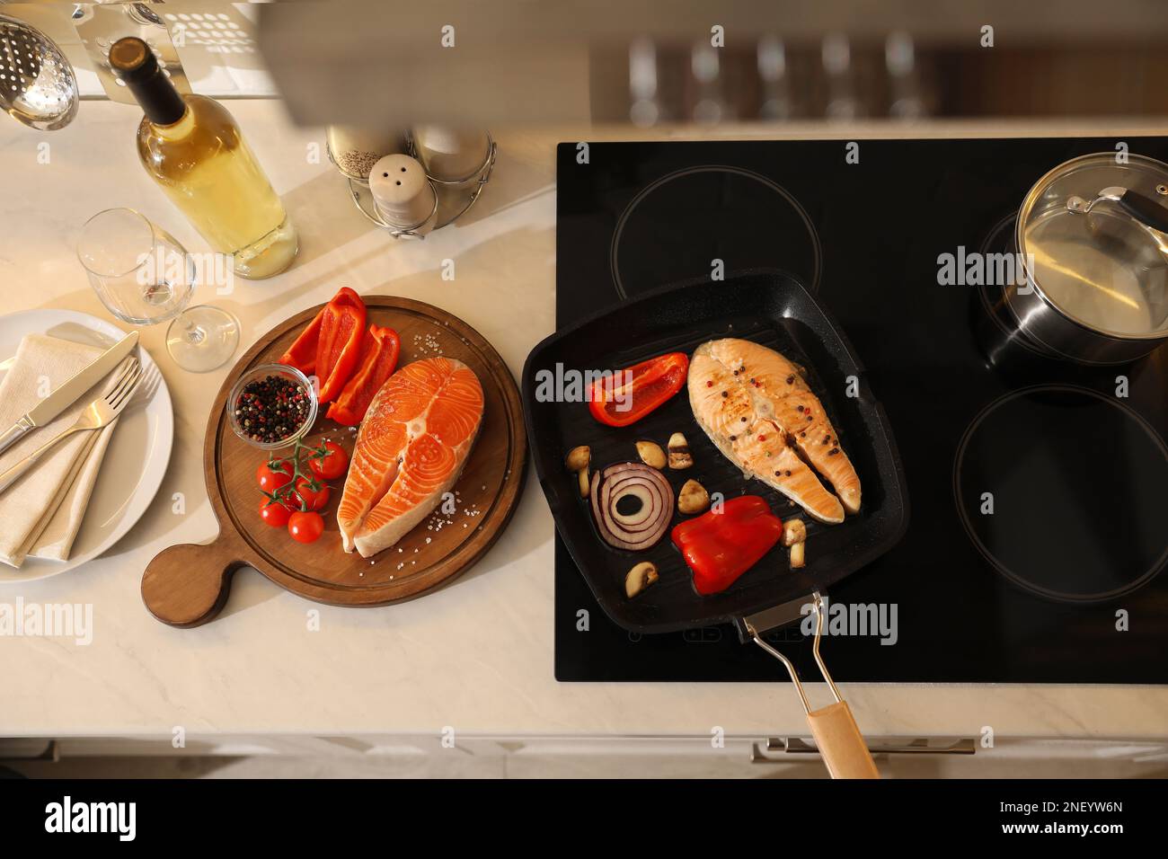 Composition with salmon steaks and vegetables in frying pan, above view ...
