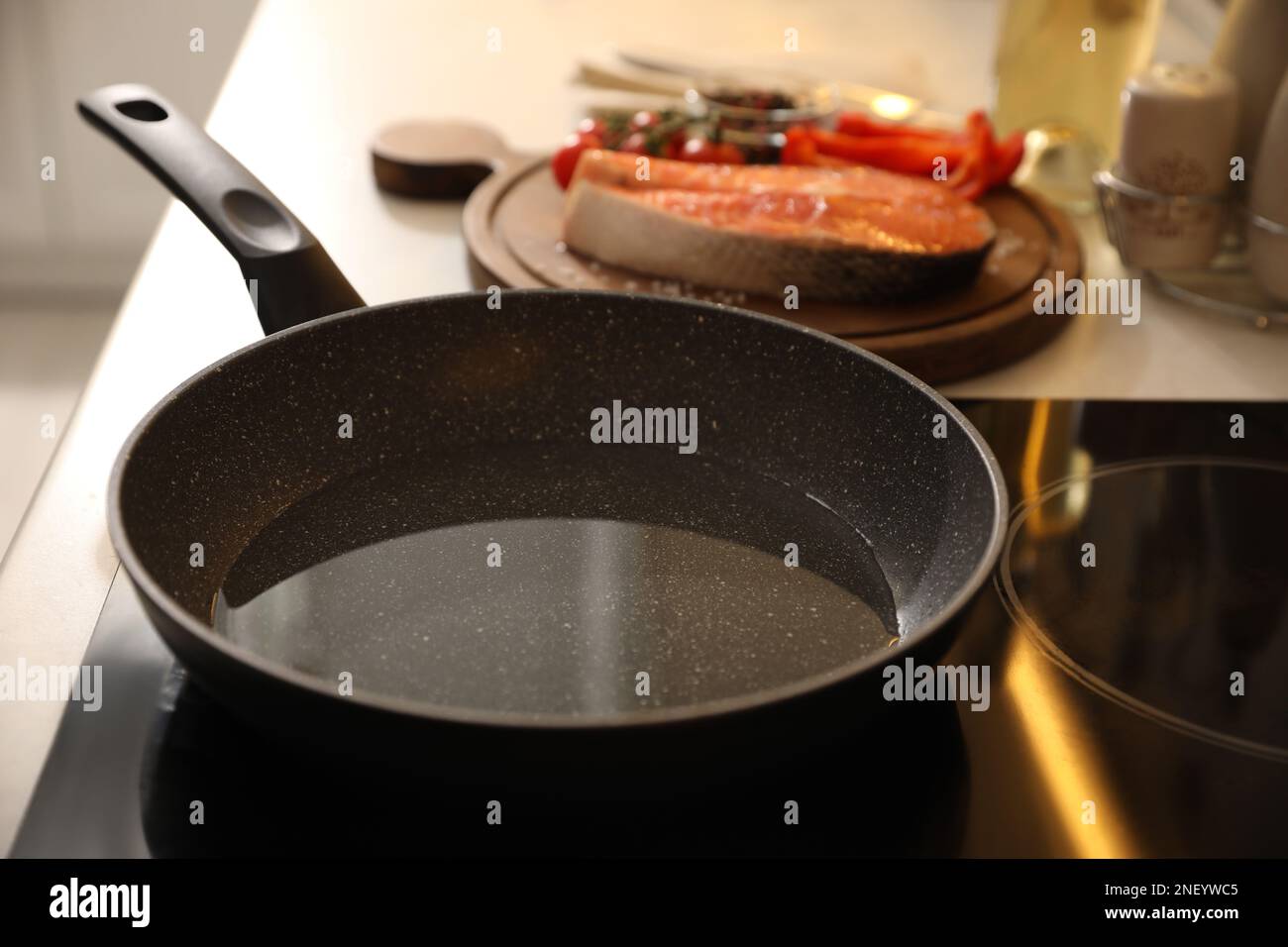 Frying pan with cooking oil on cooktop Stock Photo - Alamy