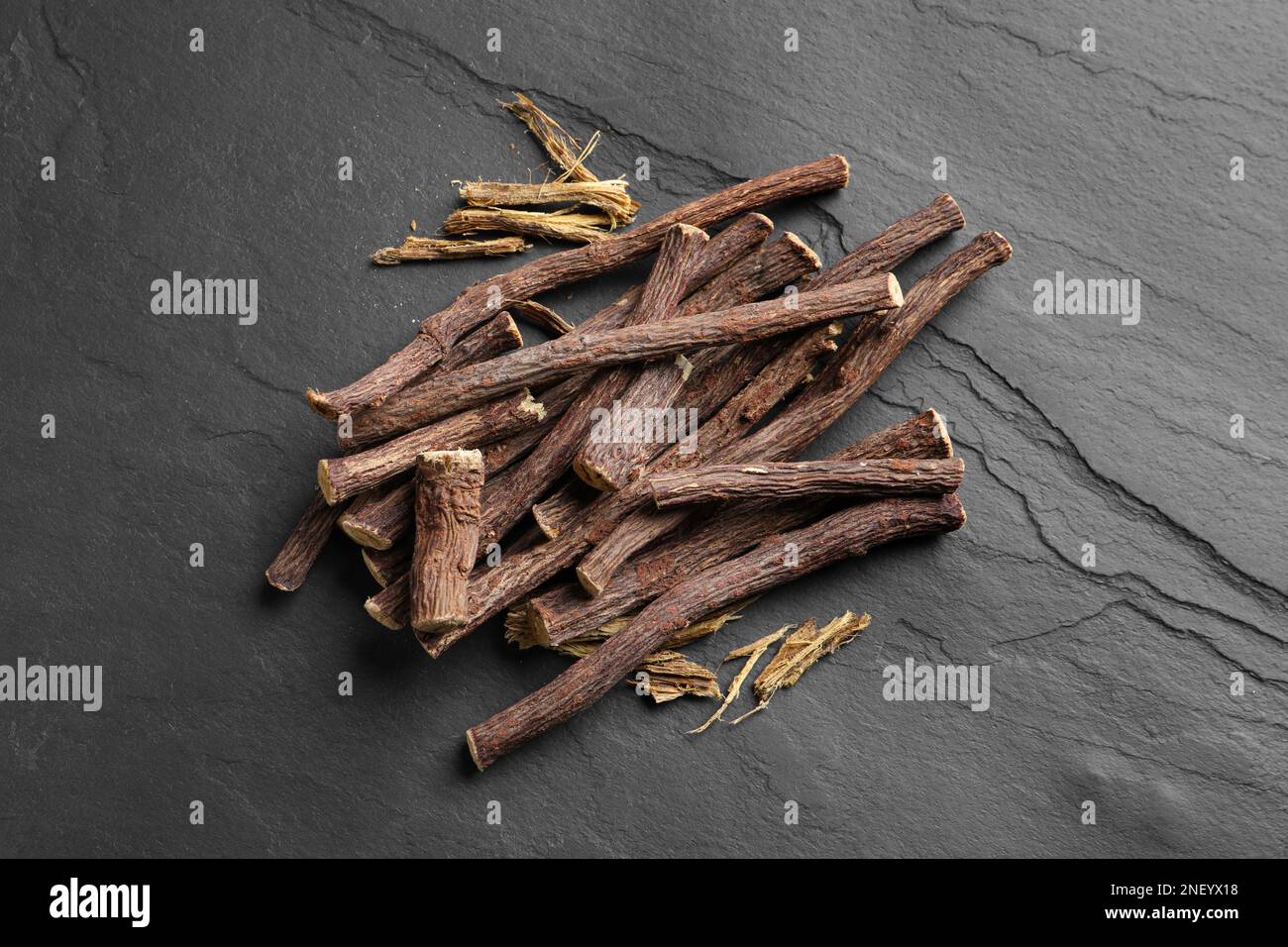 Dried sticks of liquorice root on black table, flat lay Stock Photo - Alamy