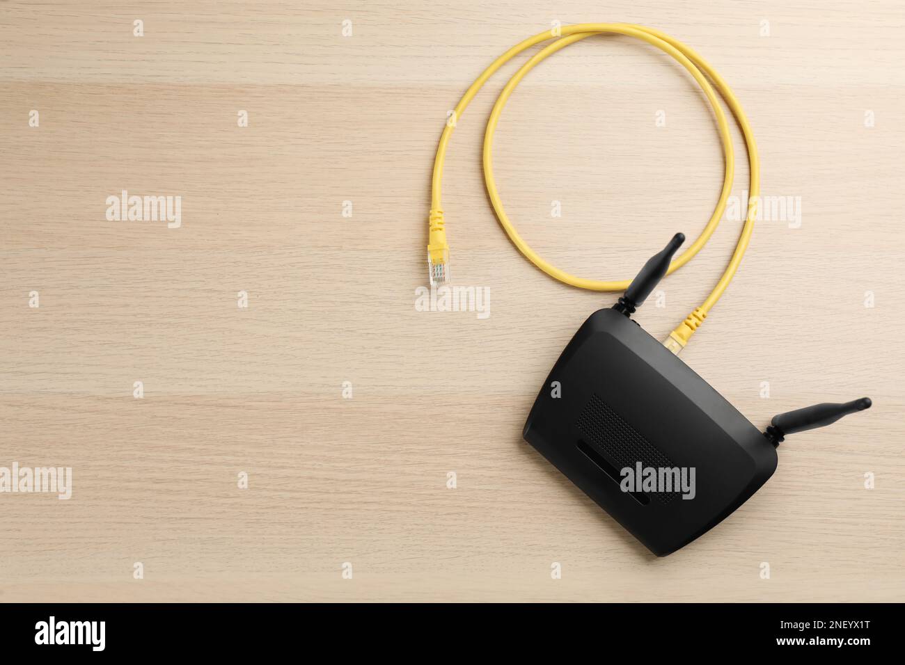 Modern Wi-Fi router on wooden background, top view. Space for text ...