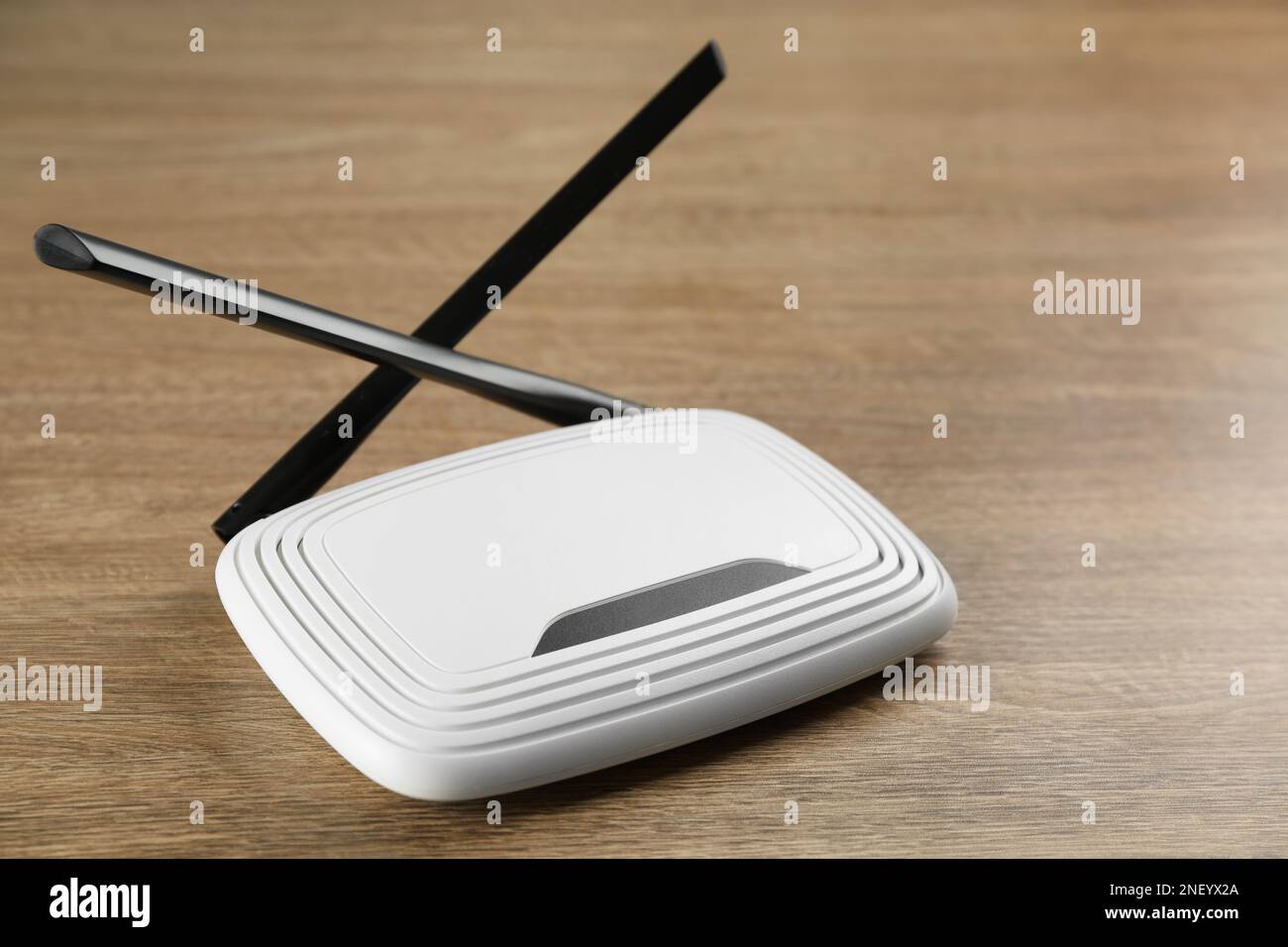 New modern Wi-Fi router on wooden background Stock Photo - Alamy