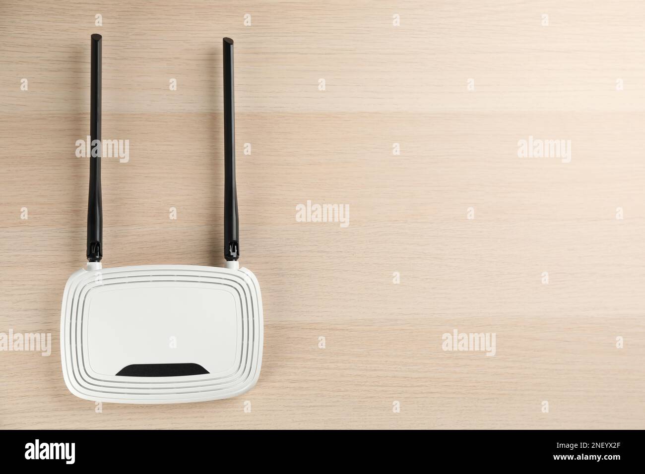Modern Wi-Fi router on wooden background, top view. Space for text ...