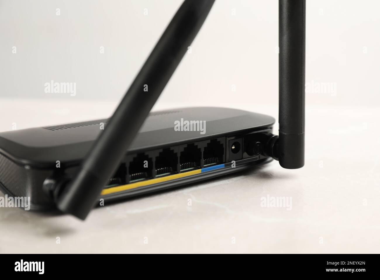 Modern Wi-Fi router on light grey marble background, closeup Stock ...