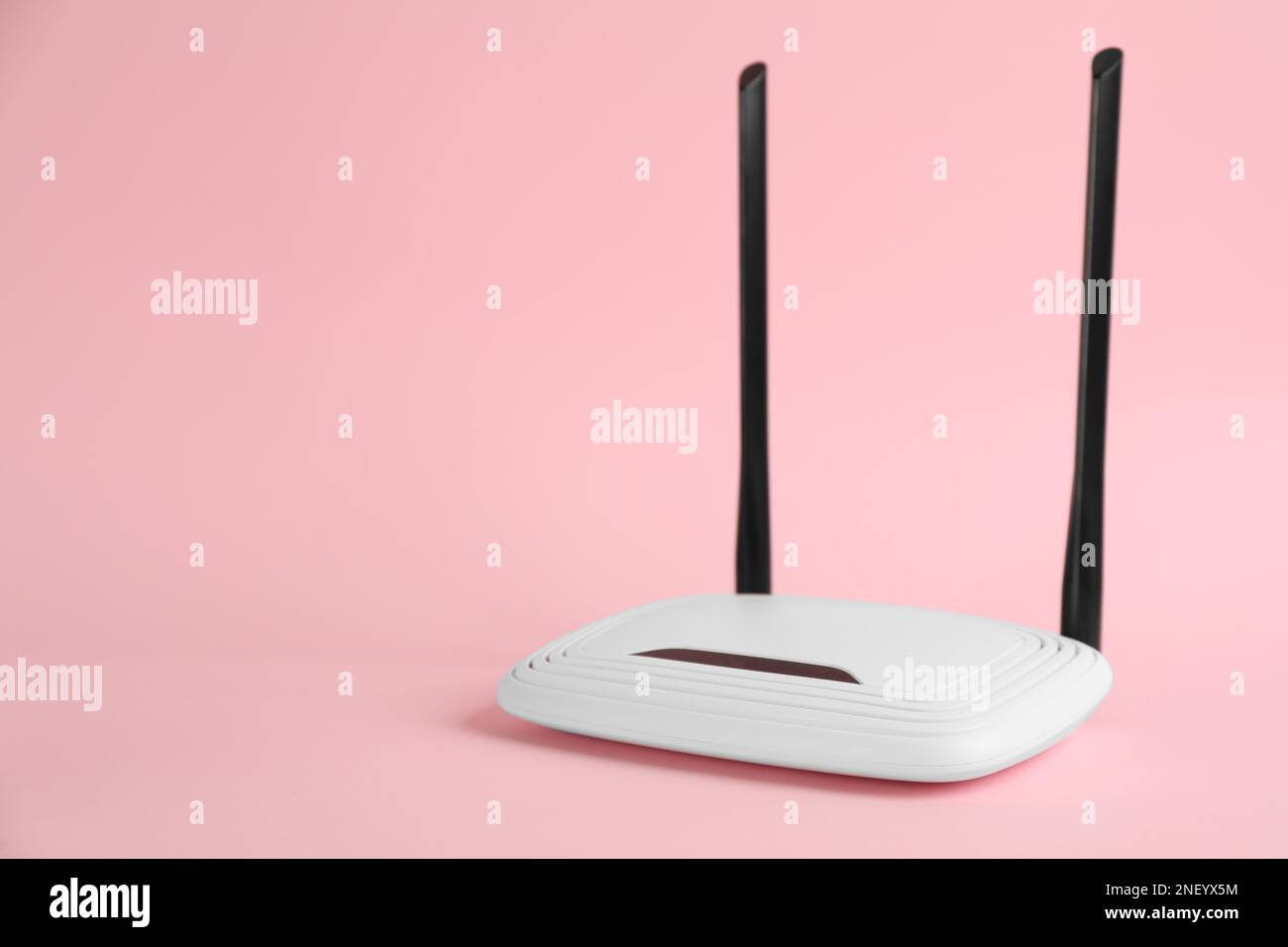 Modern Wi-Fi router on light pink background. Space for text Stock ...