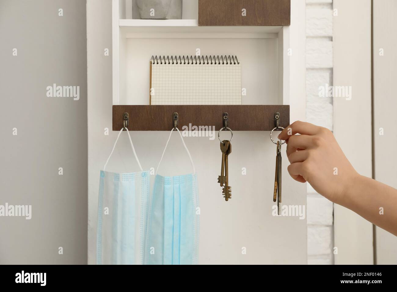 Hand putting key in door hi-res stock photography and images - Alamy